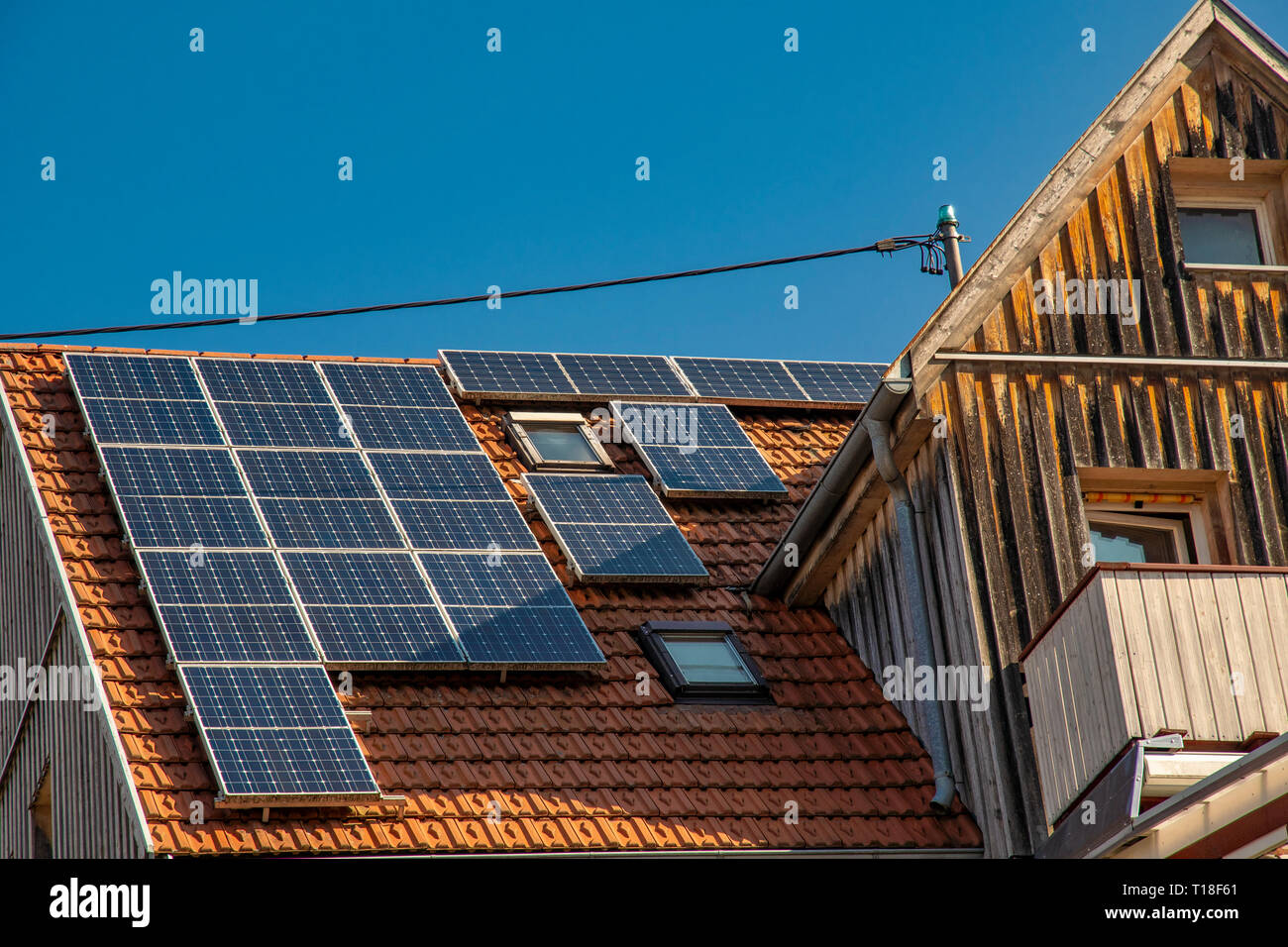 old wooden house with modern solar system on the roof and an ...