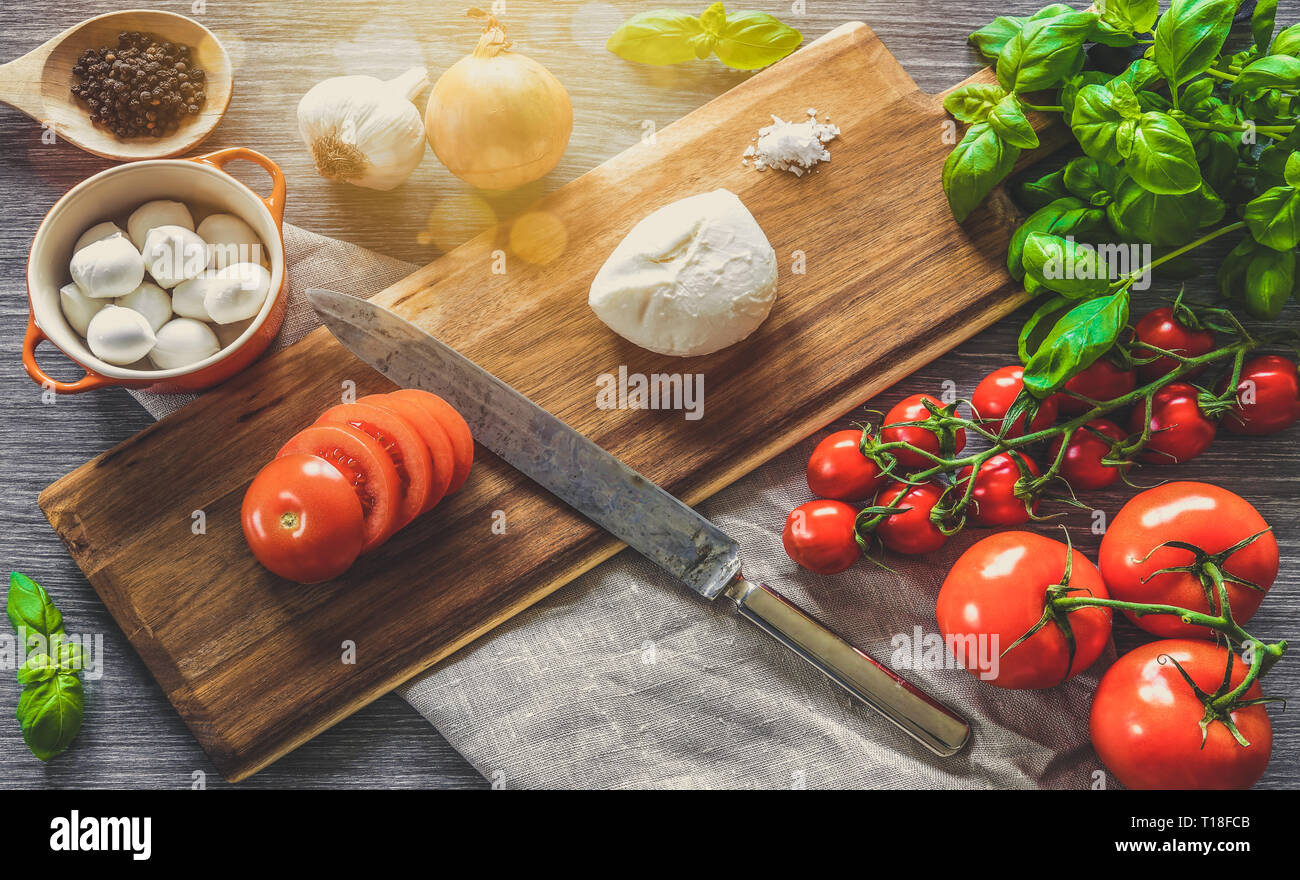 Italian food. Wooden cutting board surrounded by cooking ingredients ...