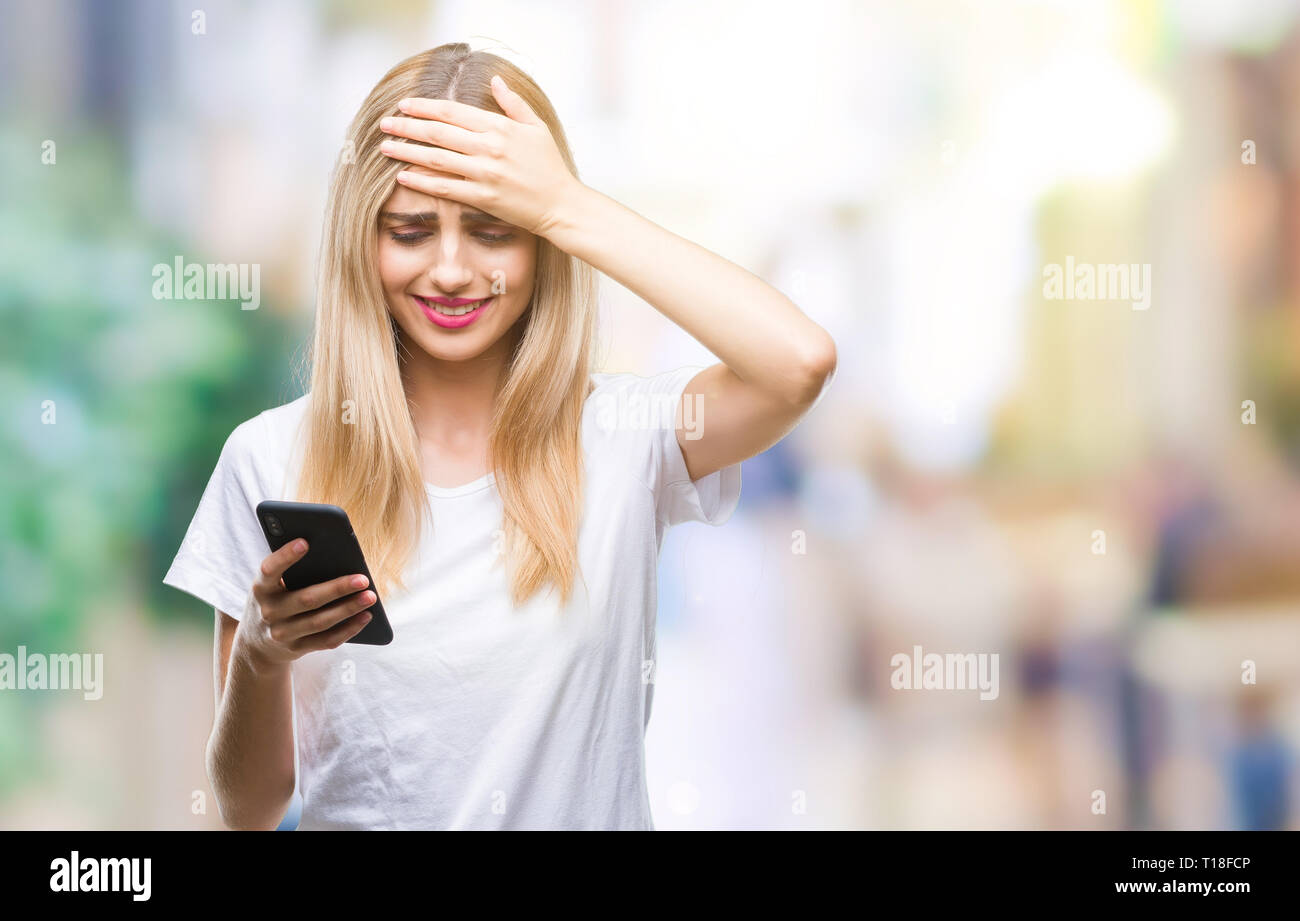Young beautiful blonde woman using smartphone over isolated background ...