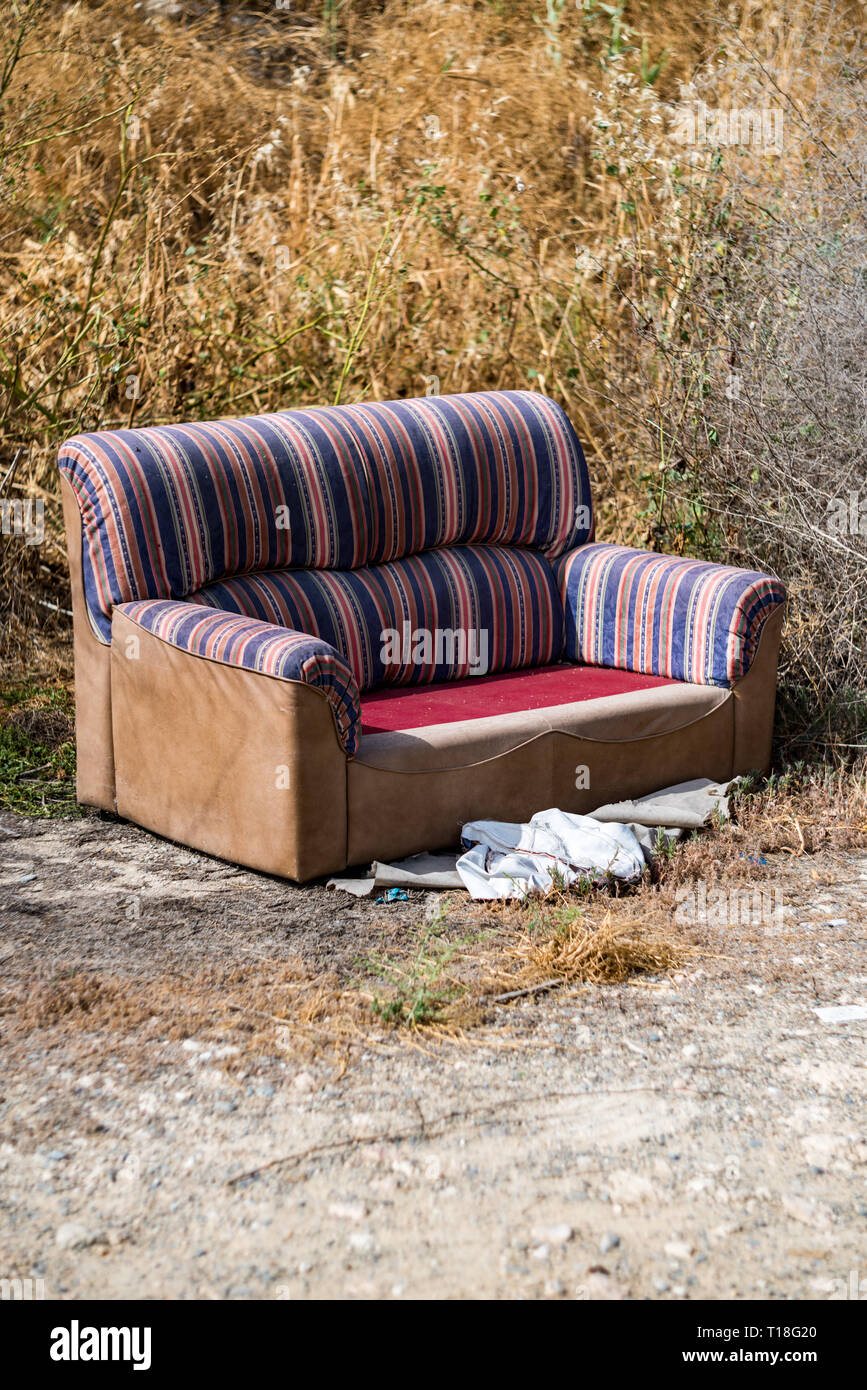 Sofa thrown away in natural area - forest part - illegal dumping trash ...