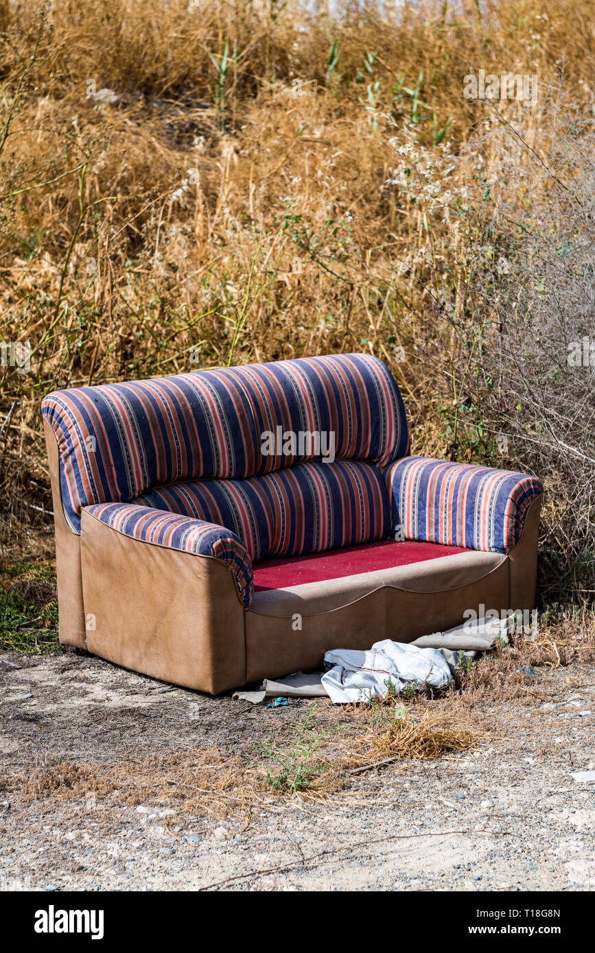 Sofa thrown away in natural area - forest part - illegal dumping trash ...