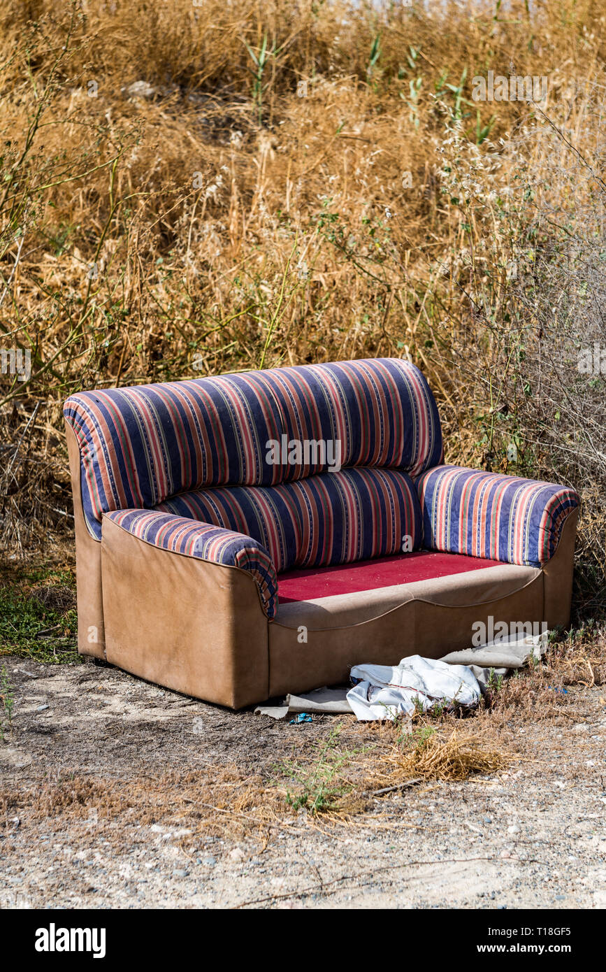 Sofa thrown away in natural area - forest part - illegal dumping trash ...