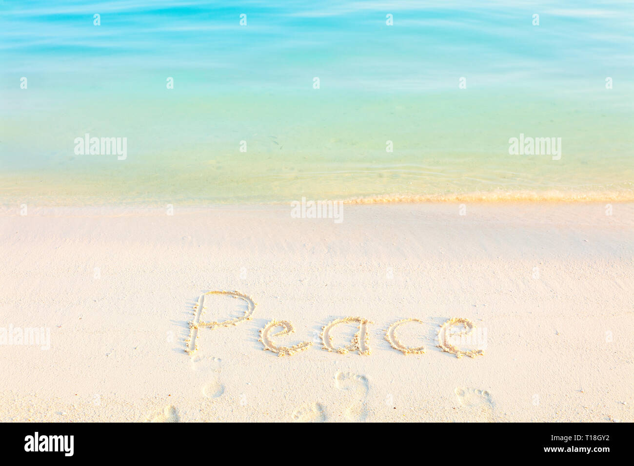 The Word Peace Written in the Sand on a Beach with morning sea ...