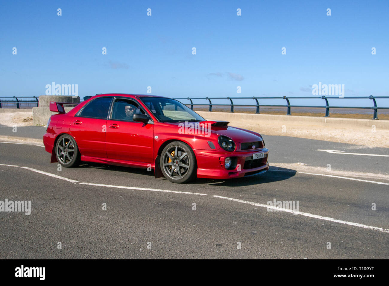 2001 Red Subaru Impreza WRX driving on the seafront promenade, Marine ...