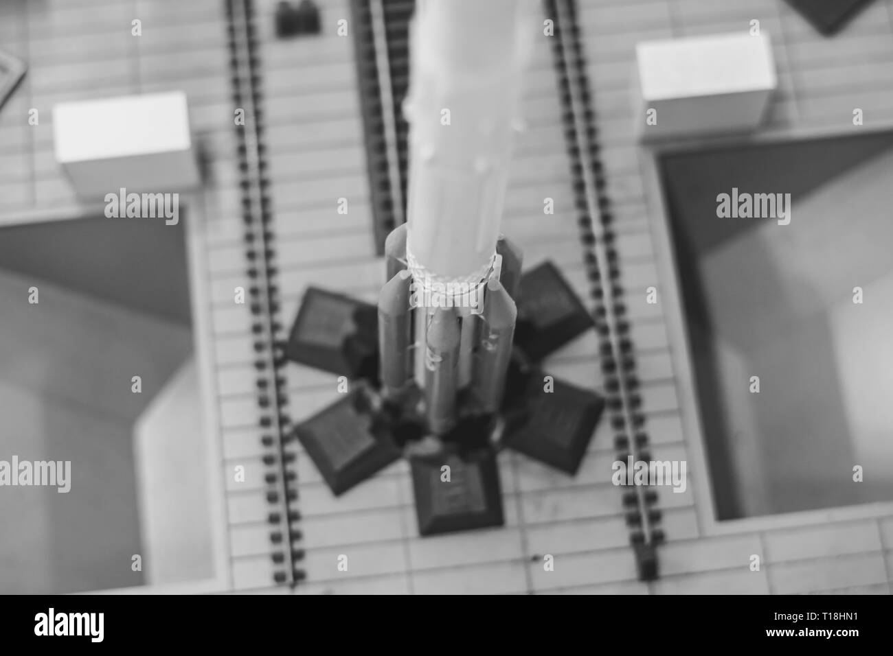 Black and white multistage space rocket model, on a miniature model of ...