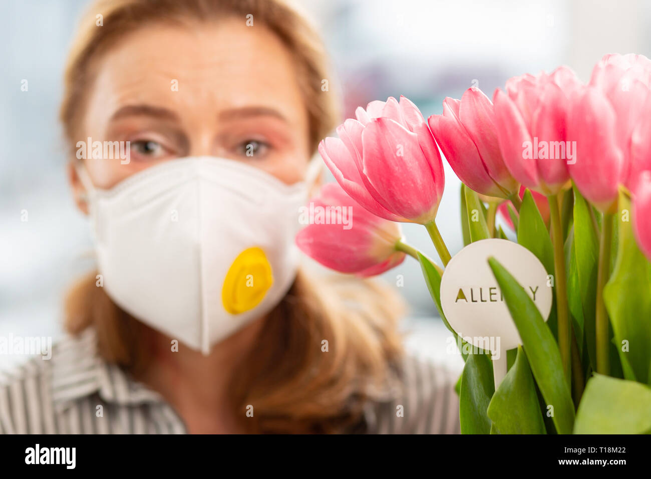 Mature woman wearing mask having strong allergy feeling bad Stock Photo ...