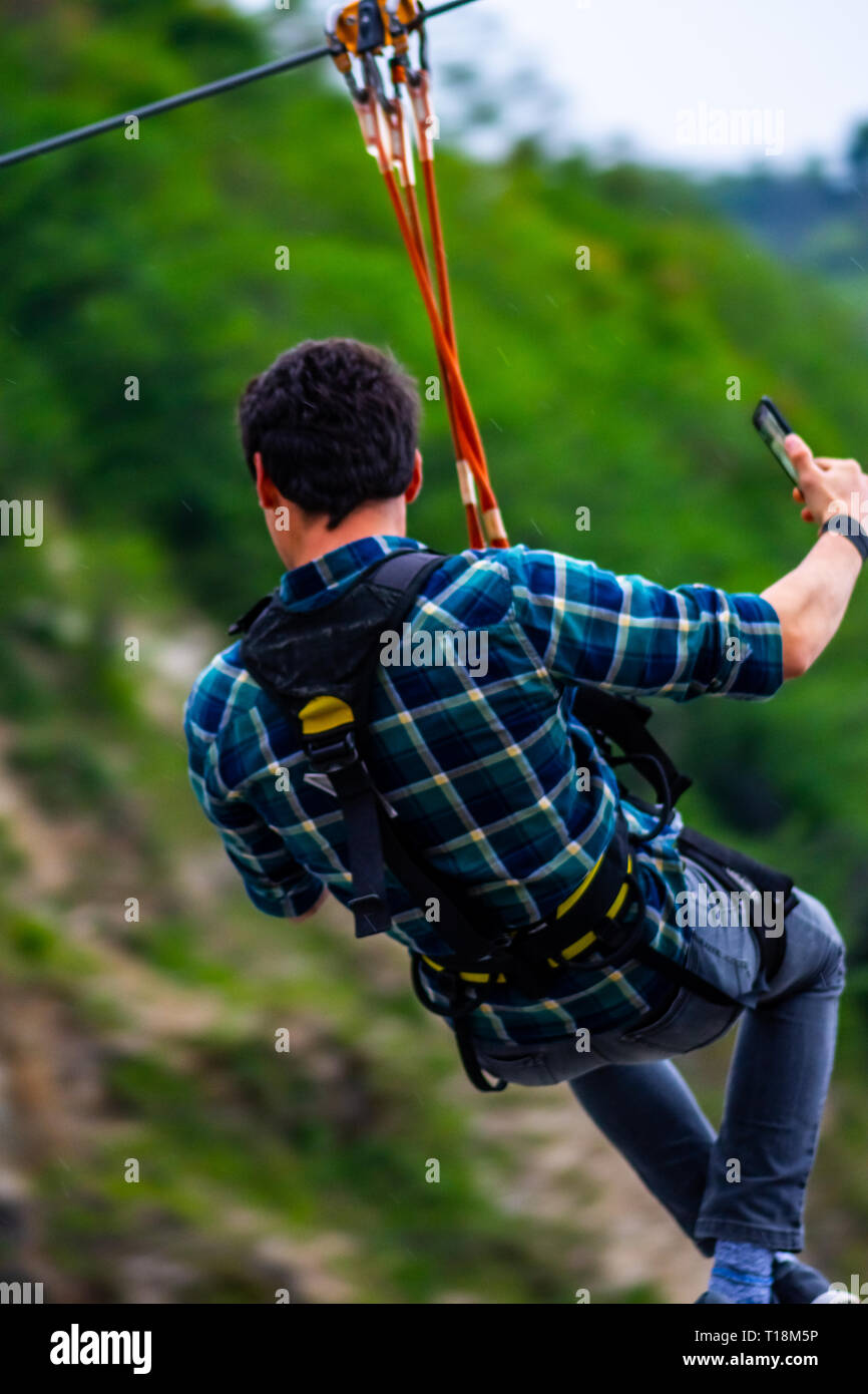The man enjoying zip line above river in Turkey Stock Photo - Alamy