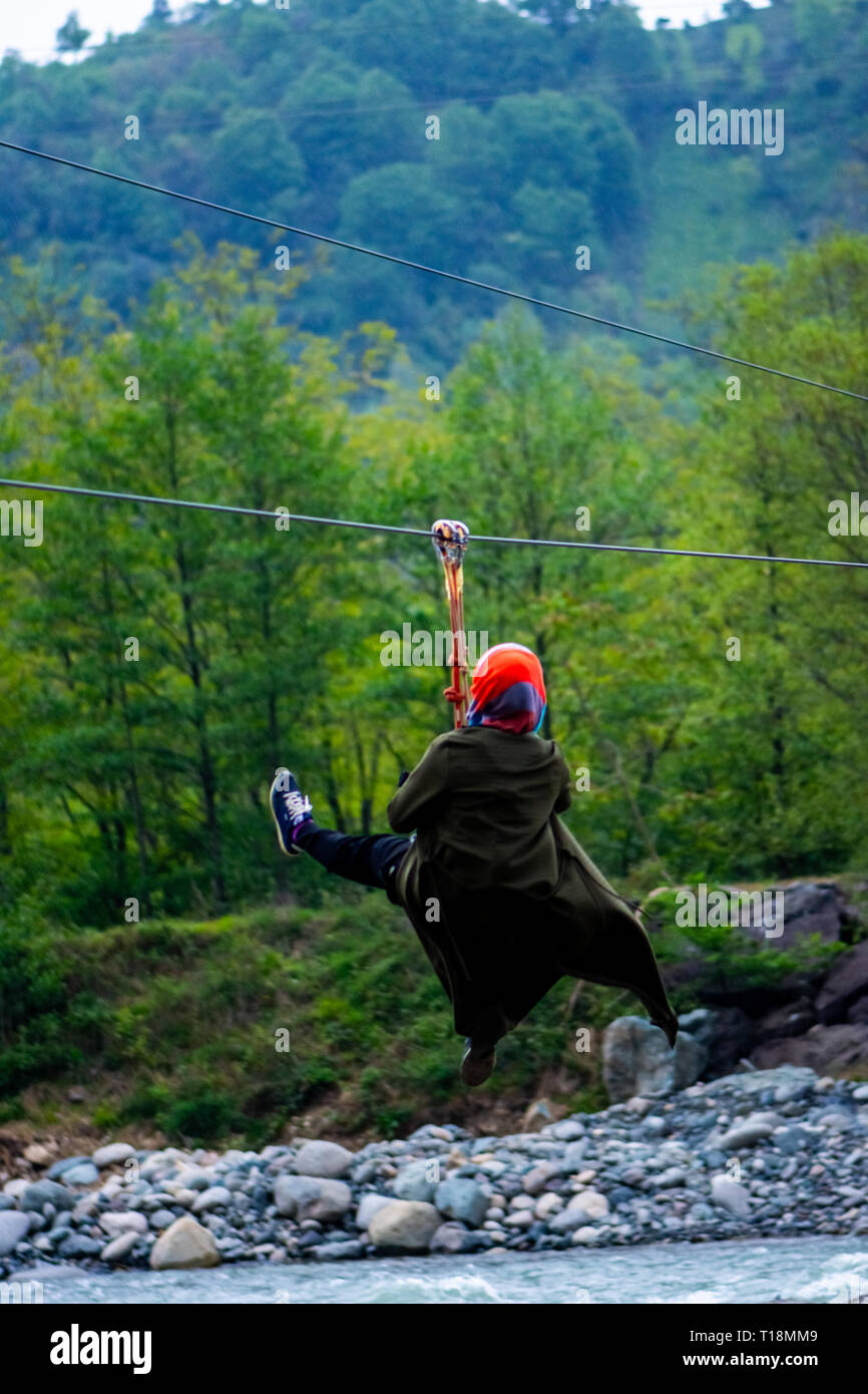 Girl enjoying zip line above the river Firtina in Turkey Stock Photo ...
