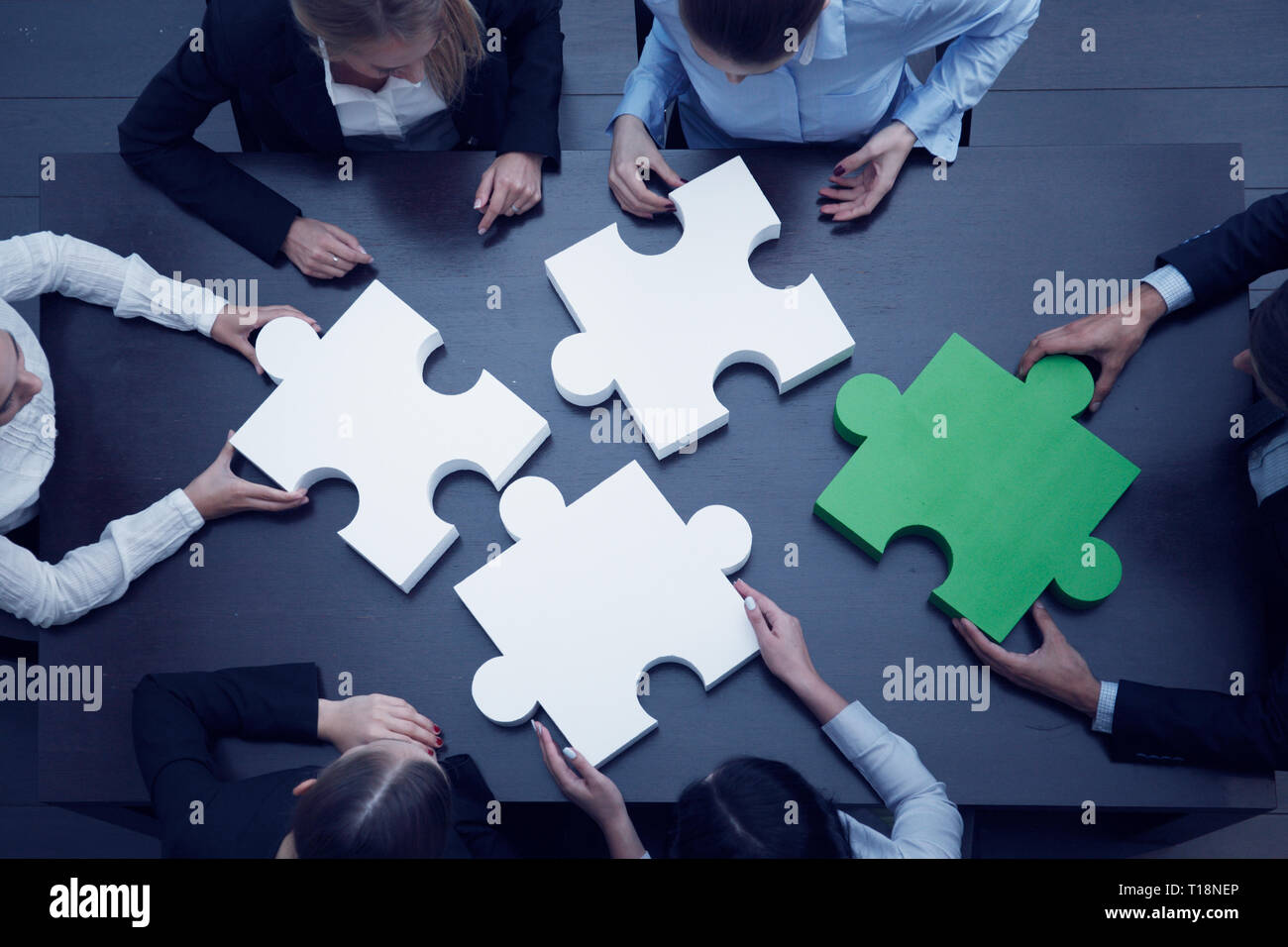 Group of business people assembling jigsaw puzzle, team support and ...