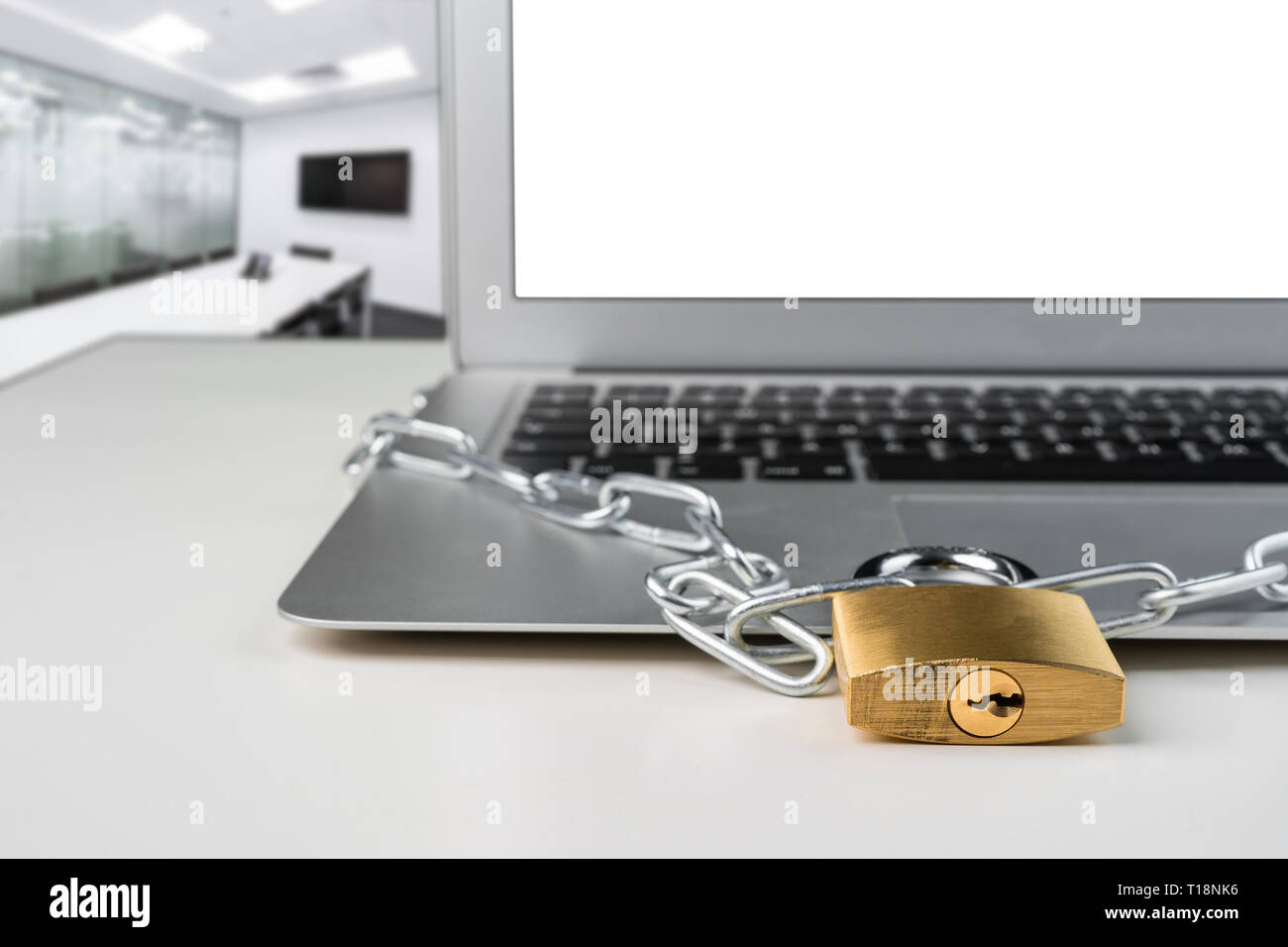 Padlock and chain with laptop computer in a presentation board office ...