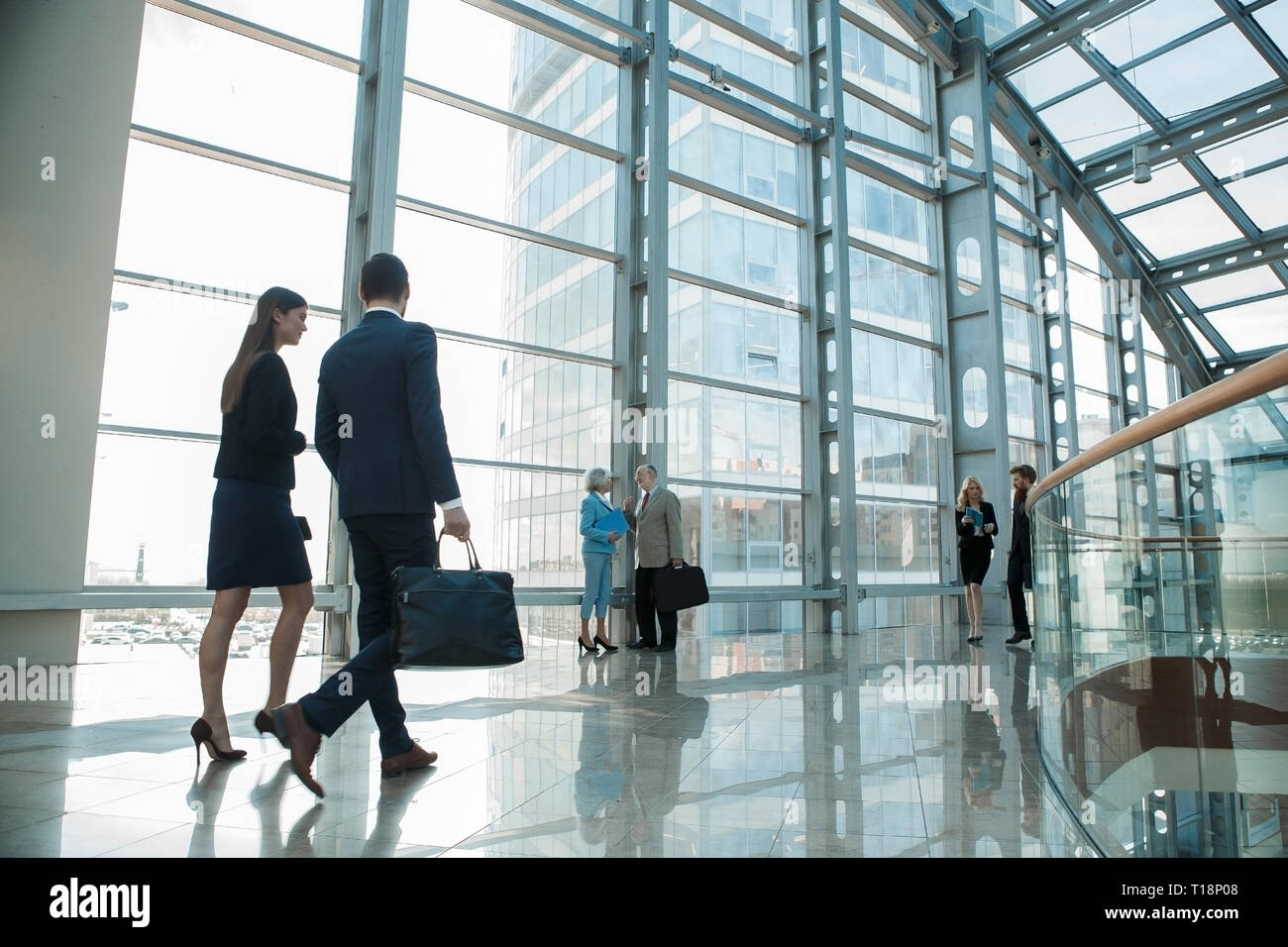 Business people walking on a modern walkway in office building Stock ...