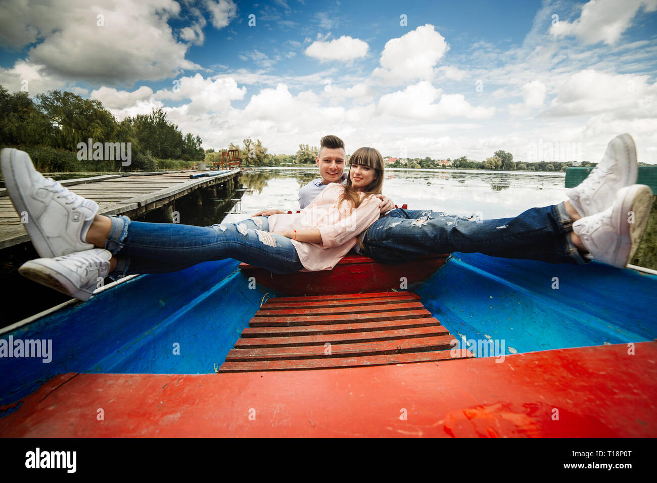 A couple riding a blue boat on a lake. romance. emotional couple Stock ...