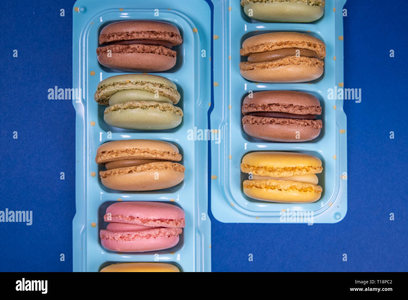 Colorful french macarons isolated on blue background placed in your ...