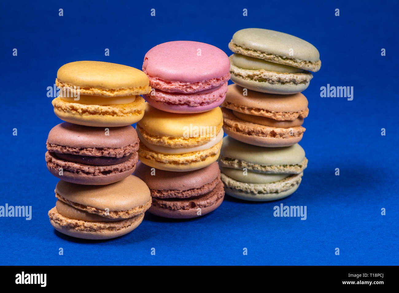 Colorful french macarons isolated on blue background. Pastel colors ...