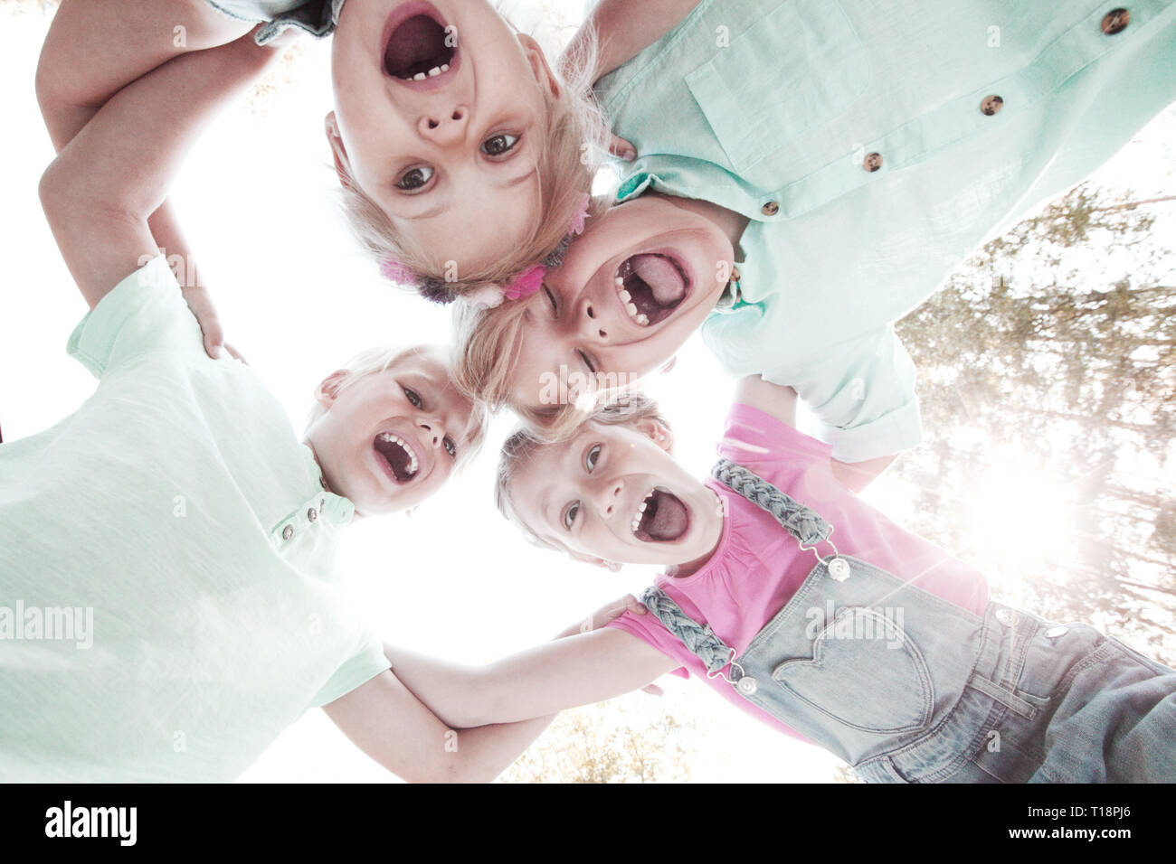 Group of smiling children looking down into camera Stock Photo - Alamy