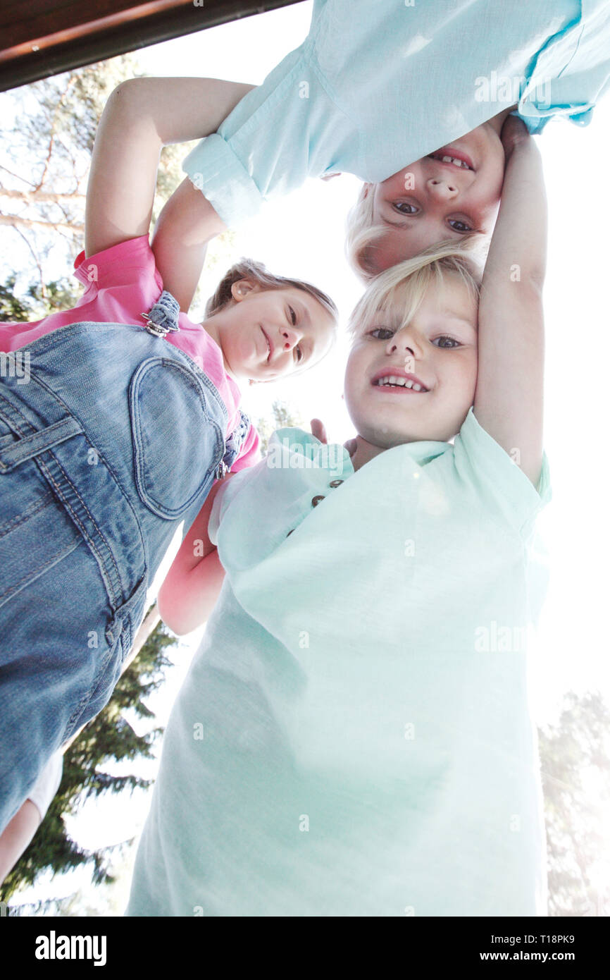 Group of smiling children looking down into camera Stock Photo - Alamy