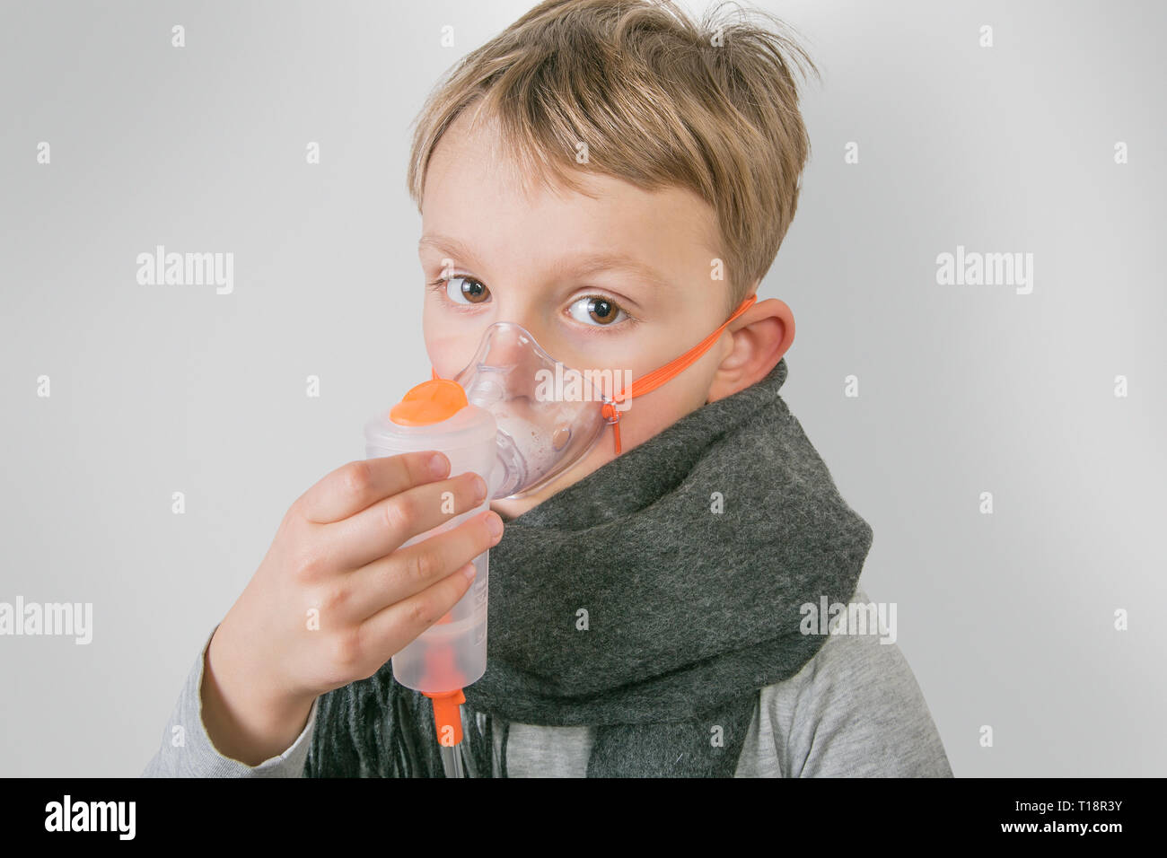 Sick boy doing inhalation Stock Photo - Alamy