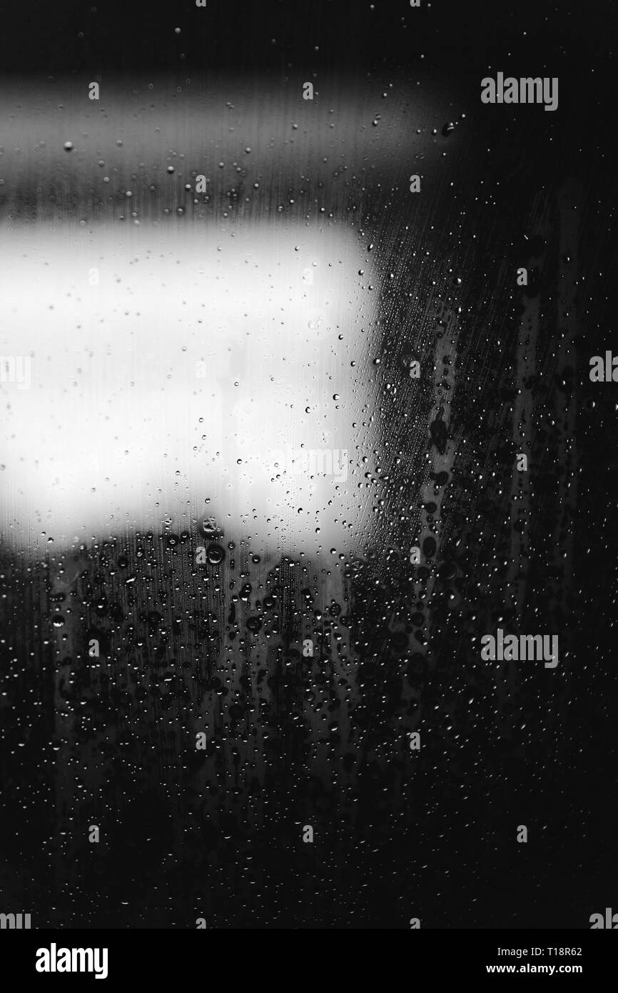 Closeup of condensation patterns on glass window, water droplets with ...
