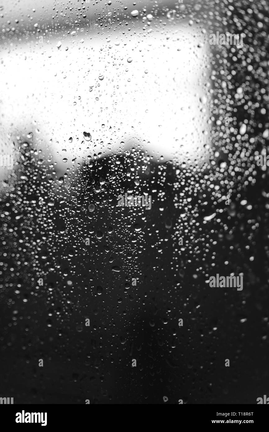 Closeup of condensation patterns on glass window, water droplets with ...