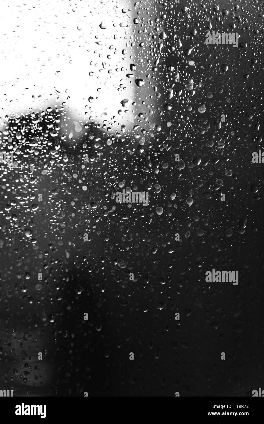 Closeup of condensation patterns on glass window, water droplets with ...