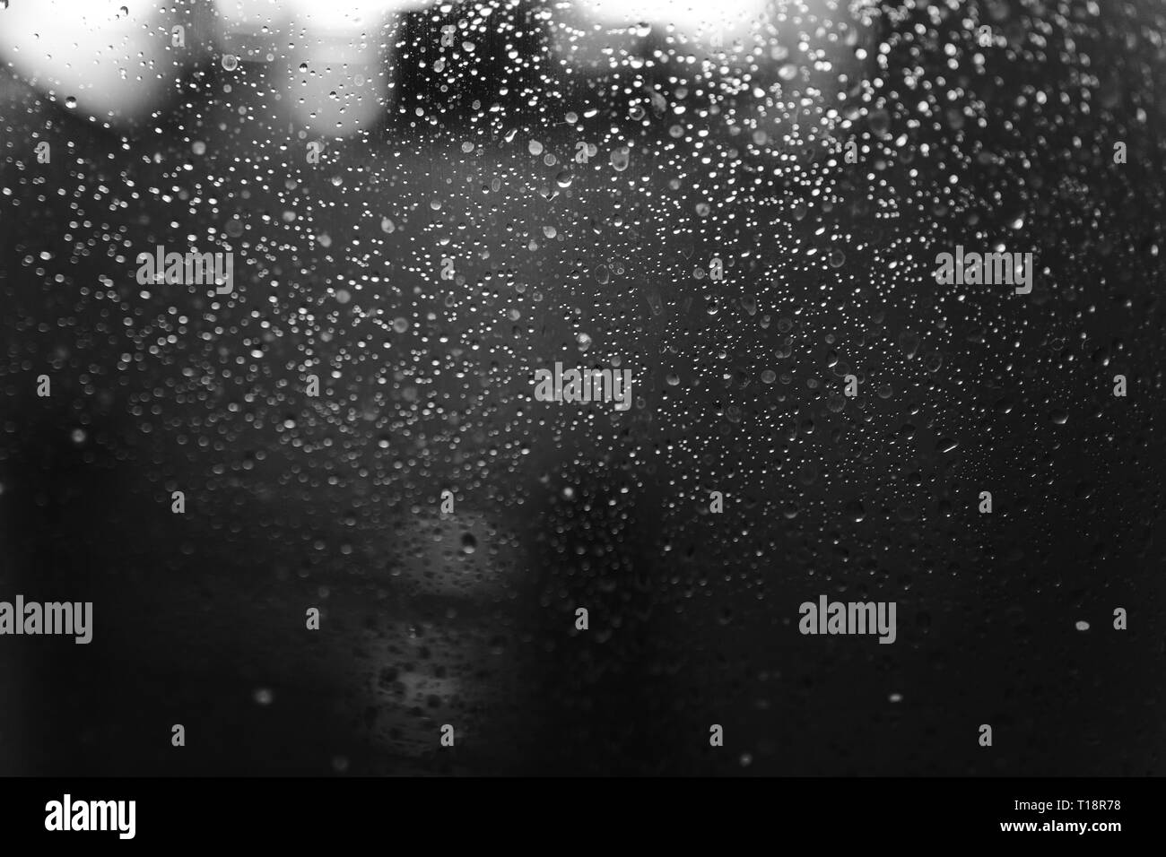 Closeup of condensation patterns on glass window, water droplets with ...