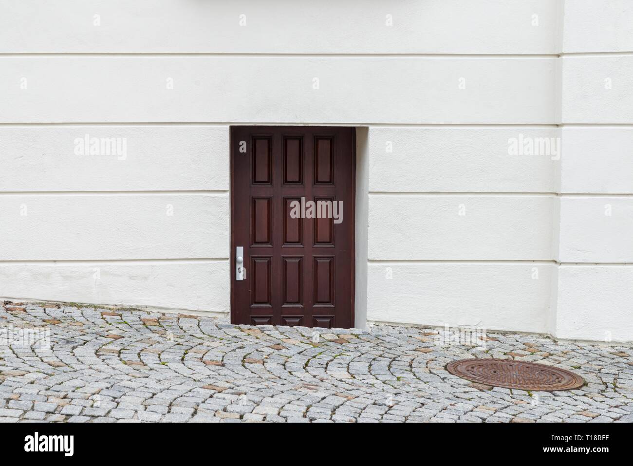 Curious wooden front door sunk in the street, Germany Stock Photo - Alamy