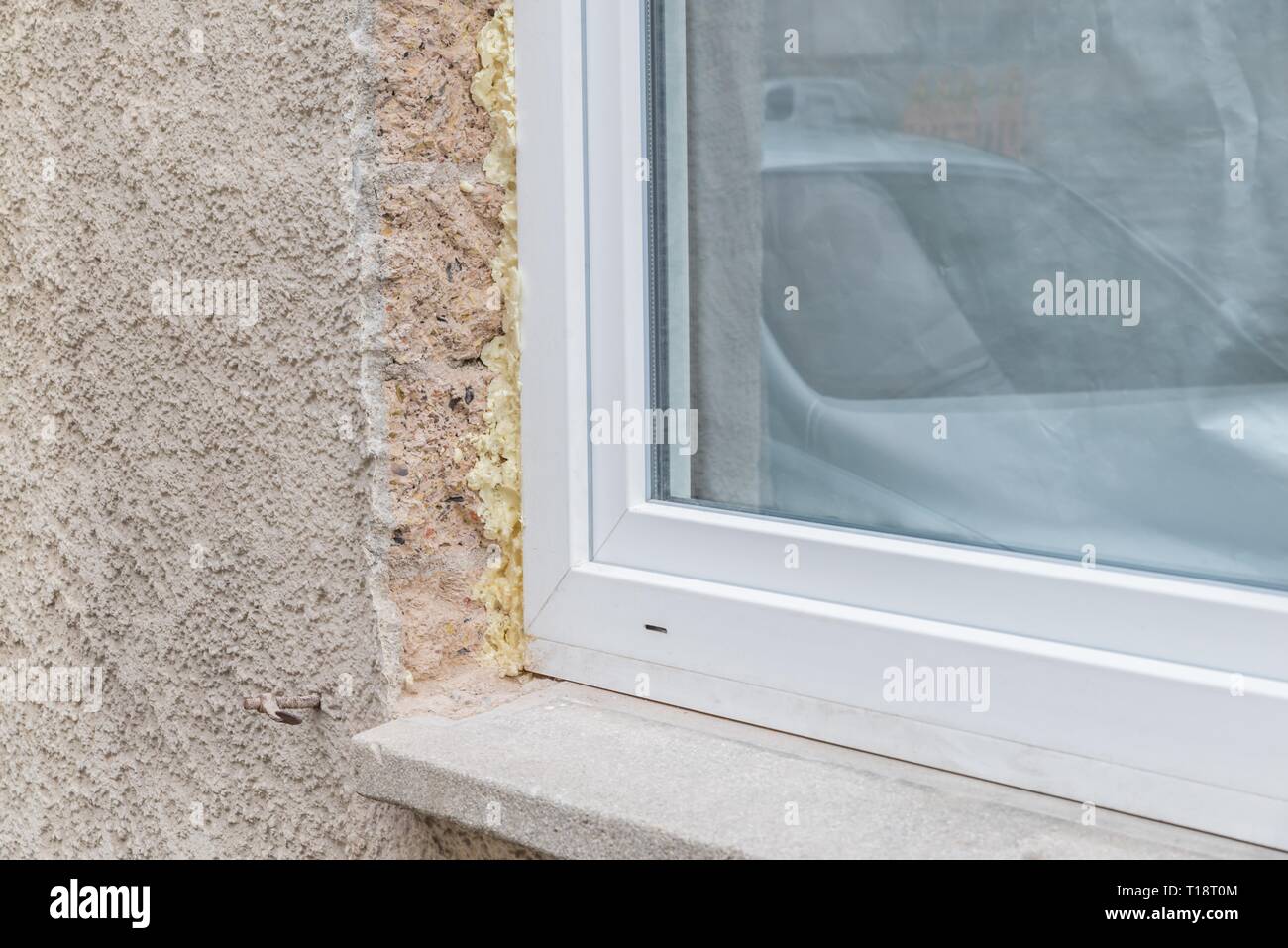 Close-up of a window in the shell with construction foam and window ...