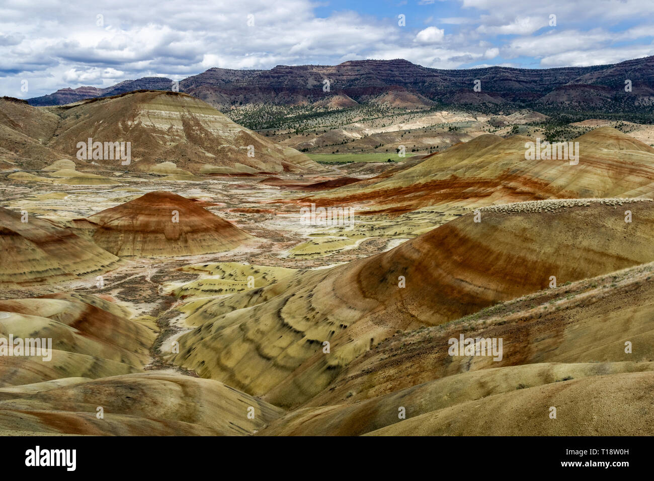 Eroded sedimentary rock formation with colorful geological layers ...