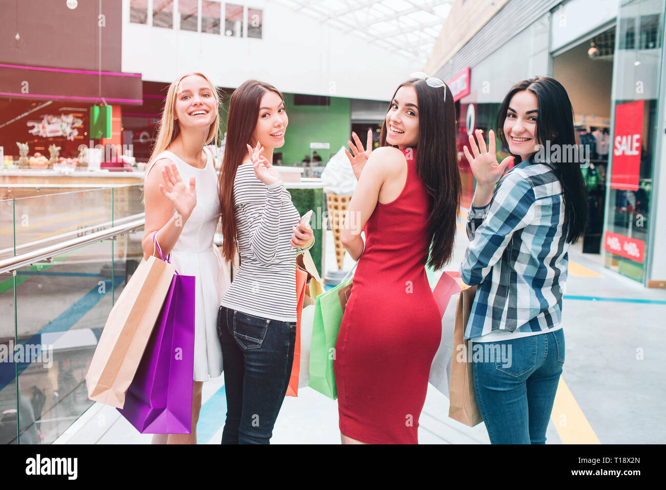 Awesome and well-dressed girls are standing and posing. They are ...