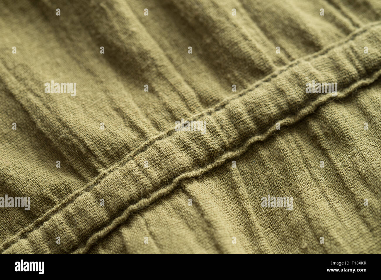 olive green creased fabric dress detail Stock Photo - Alamy