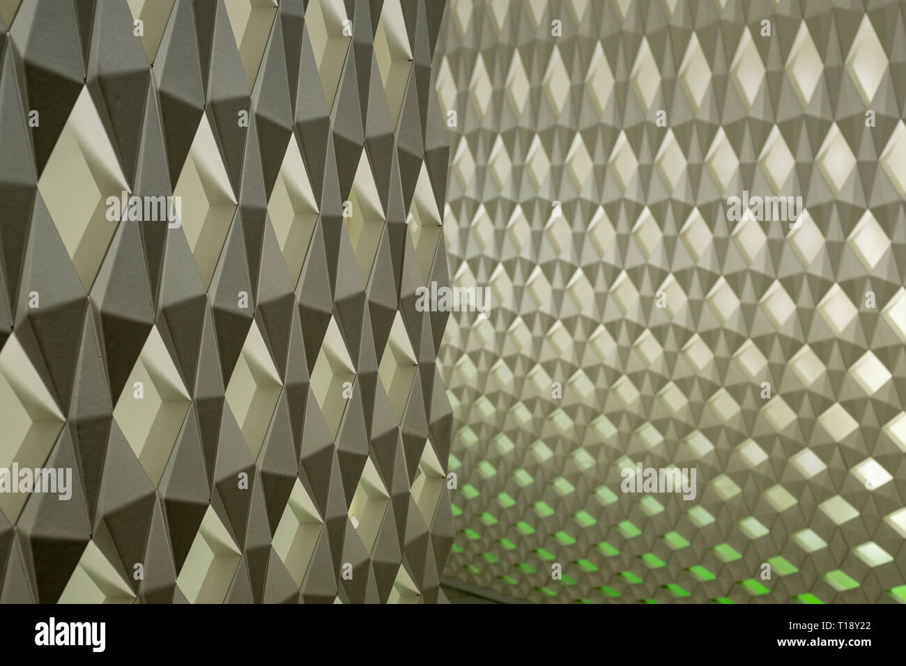 Geometric wall pattern with green background lights Stock Photo - Alamy
