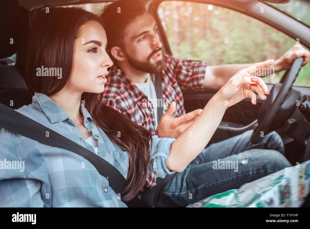 Nice and attractive couple are looking straight forward. Guy is keeping ...