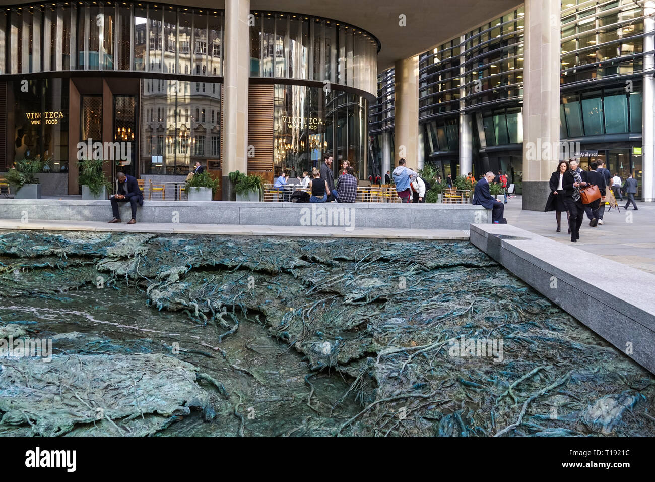 People sitting around sculpture Forgotten Streams by Cristina Iglesias ...