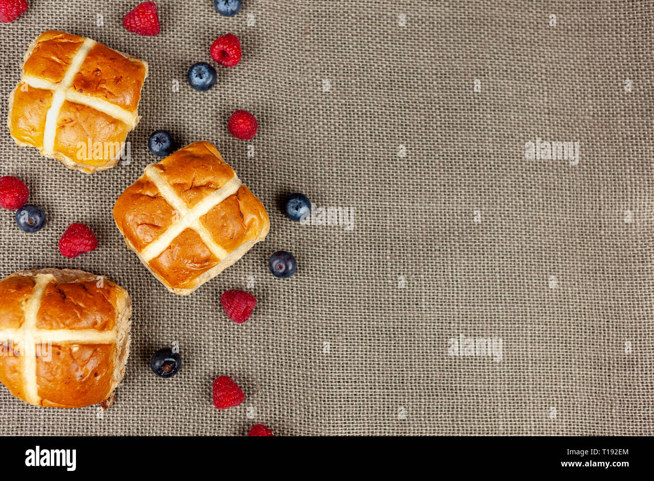 Hot cross buns with blueberries and raspberries on a muslin cloth Stock ...