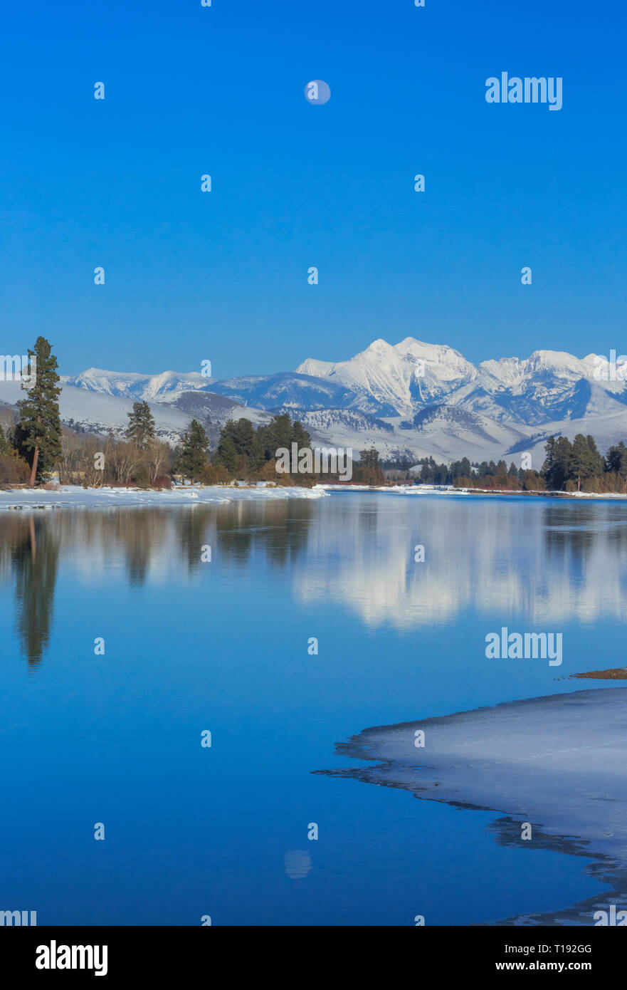 moon rising over the flathead river and mission mountains in winter ...