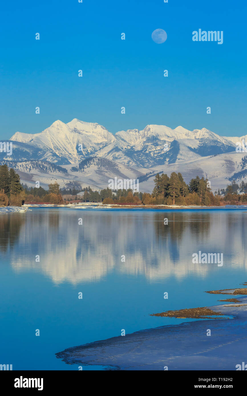 moon rising over the flathead river and mission mountains in winter ...