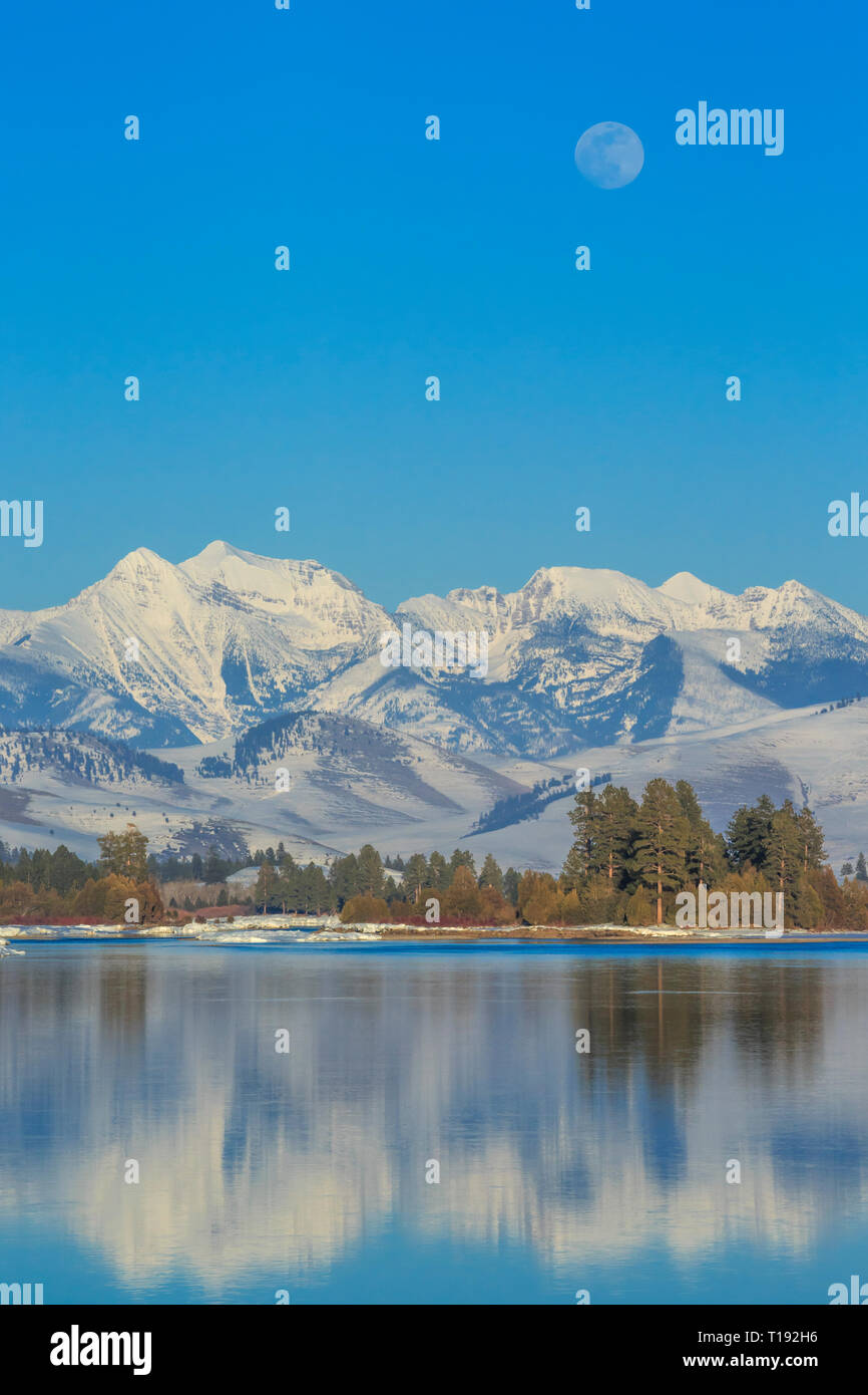 moon rising over the flathead river and mission mountains in winter ...