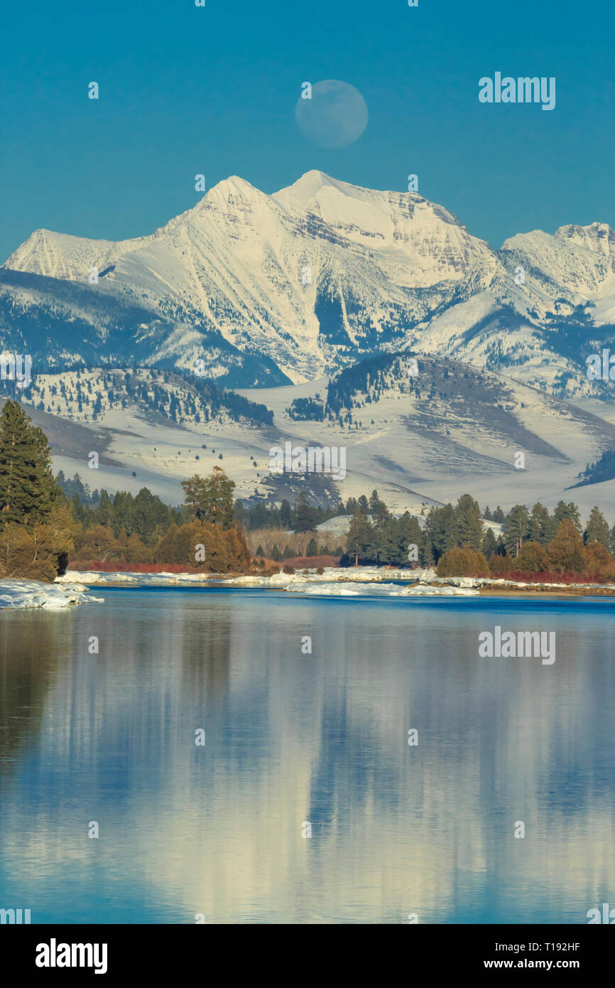 moon rising over the flathead river and mission mountains in winter ...