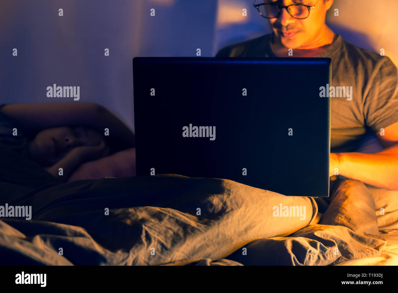 Working in bed at night hi-res stock photography and images - Alamy