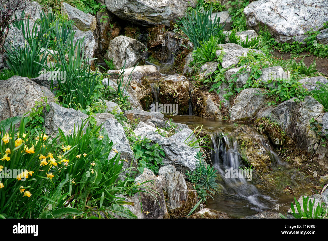 Flowing water stream, water drops and reflection Stock Photo - Alamy