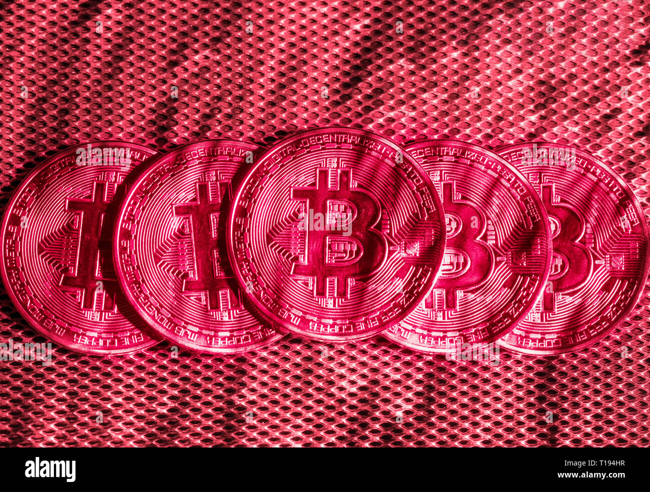 Top view of golden bit coins painted with red laser light.Bit coin ...