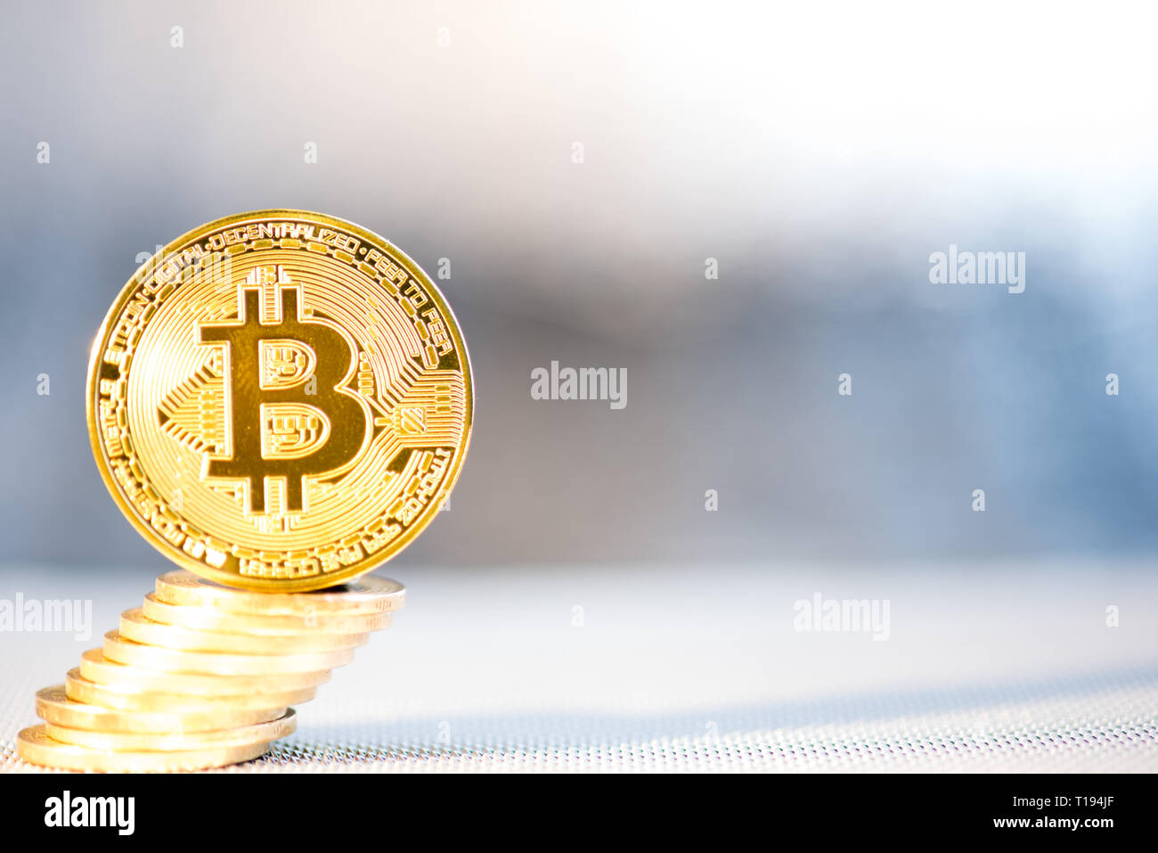 Front view of single golden bit coin with money stack on silver ...