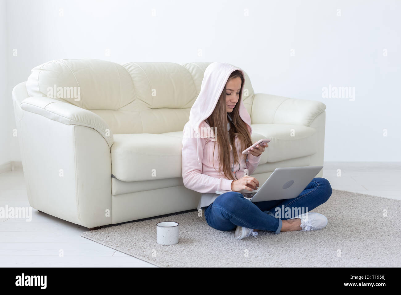 Working, cozy, people concept - young woman working at home, drinking ...
