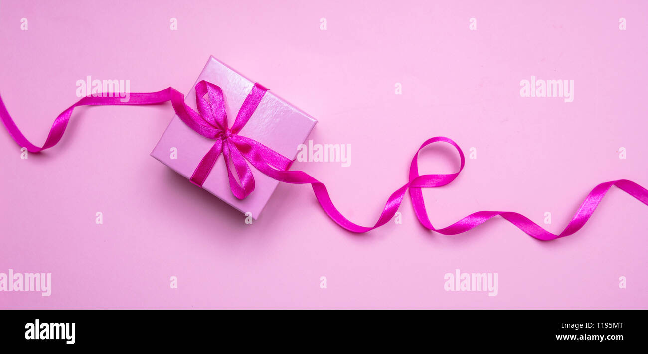 Pink gift box. Present with bright pink ribbon bow on pink background ...