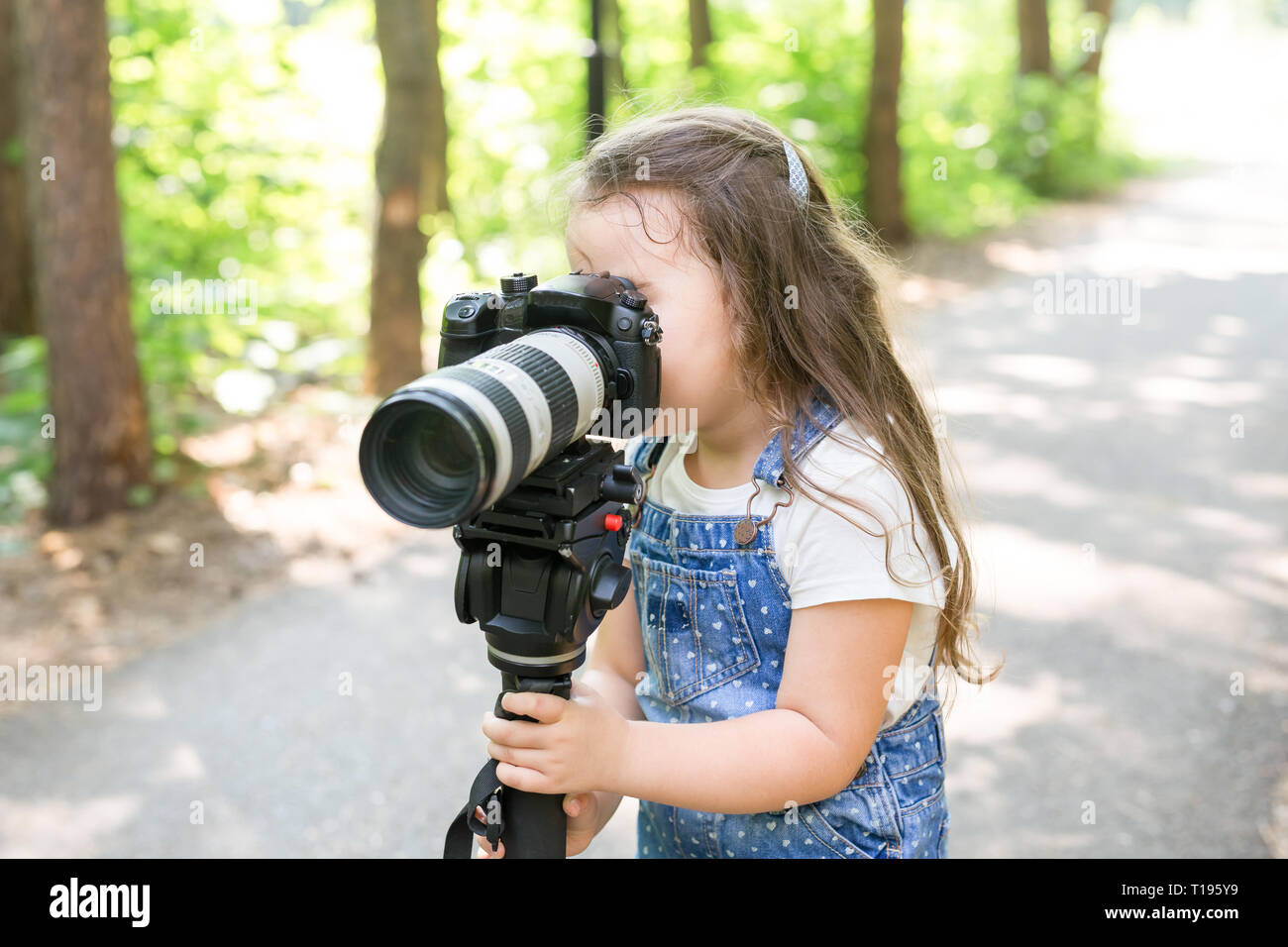 Hobby, profession, children and photographer concept - child with ...