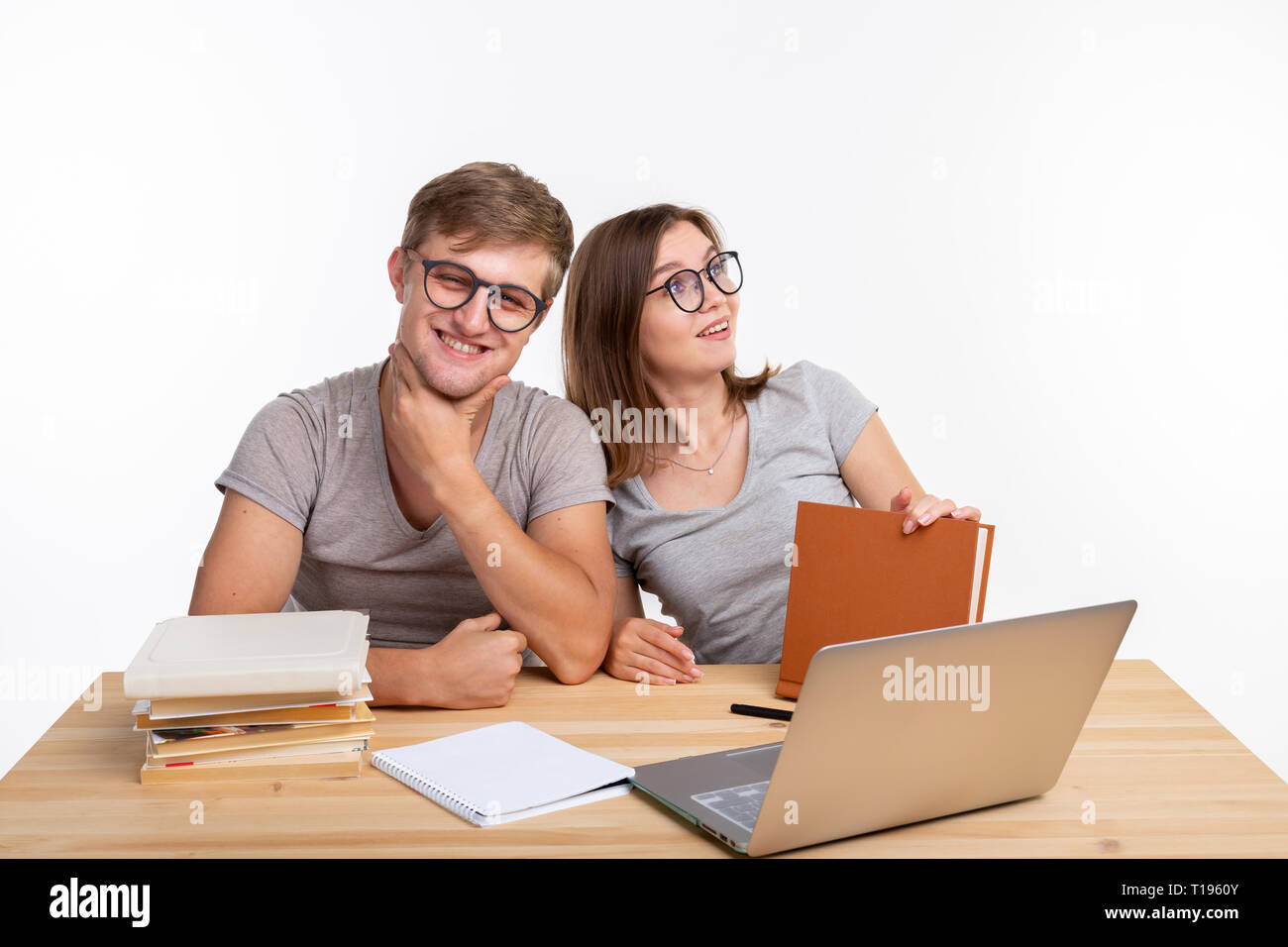 Education and student concept - a funny couple doing exercises or ...