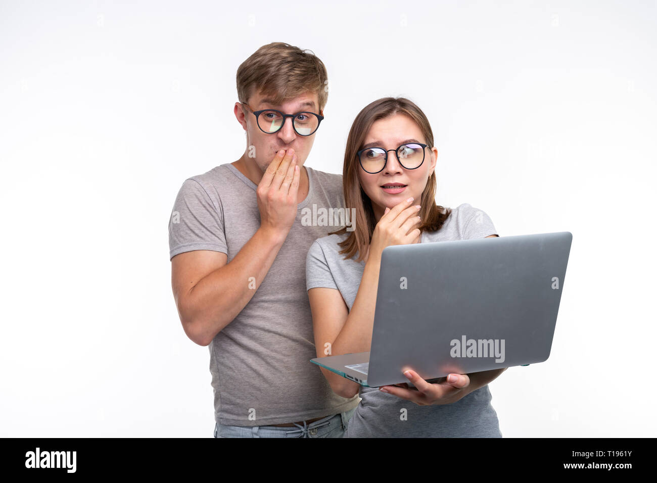 Nerds, study, people concept - a couple of people look at the laptop ...
