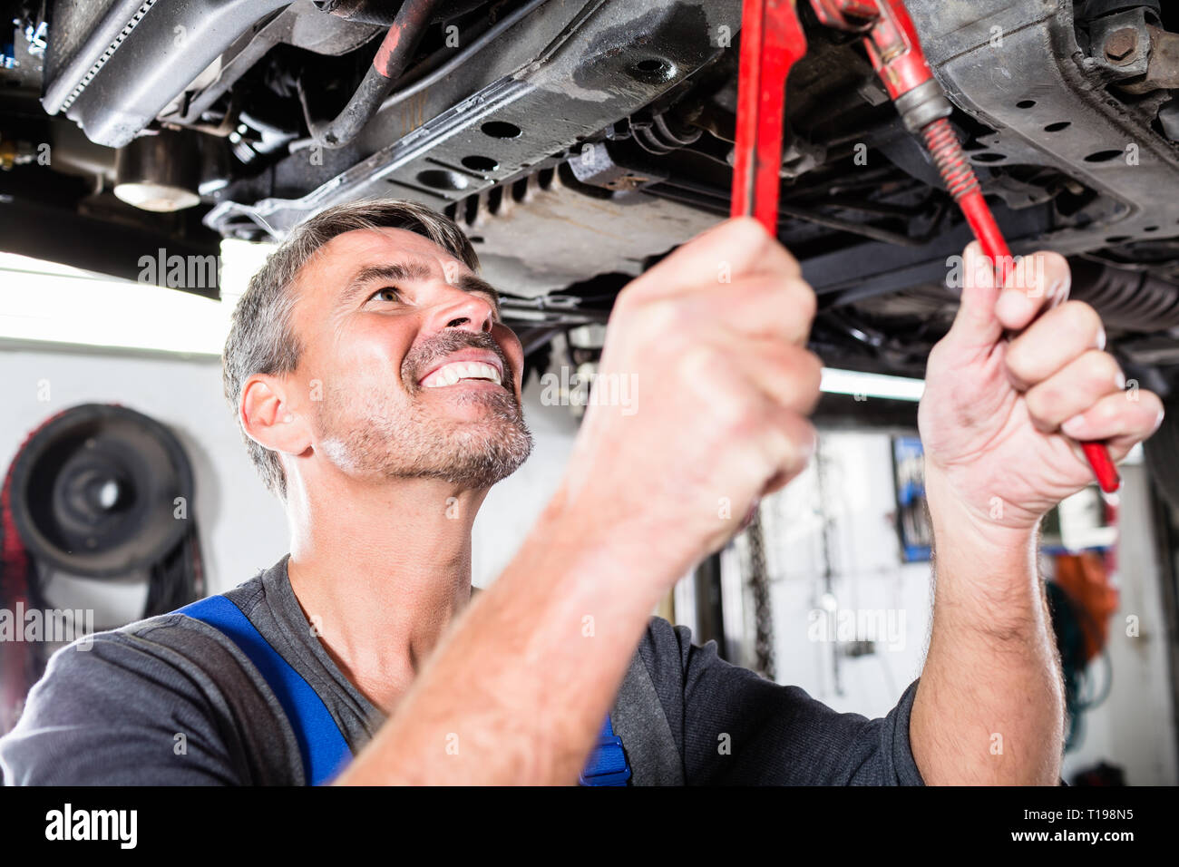 Man under car and garage hi-res stock photography and images - Alamy