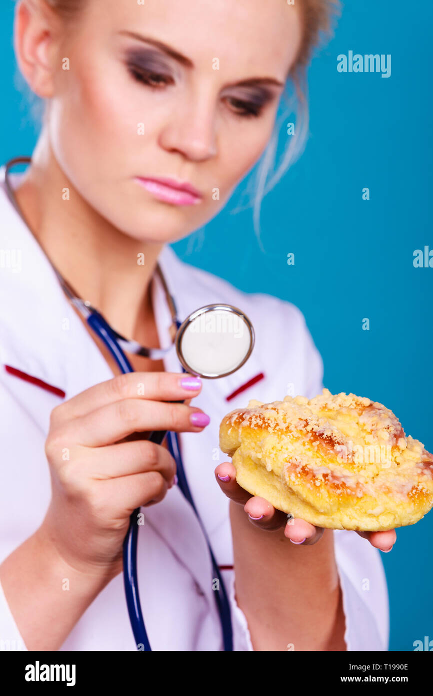 Serious dietitian nutritionist checking examine sweet roll bun with ...