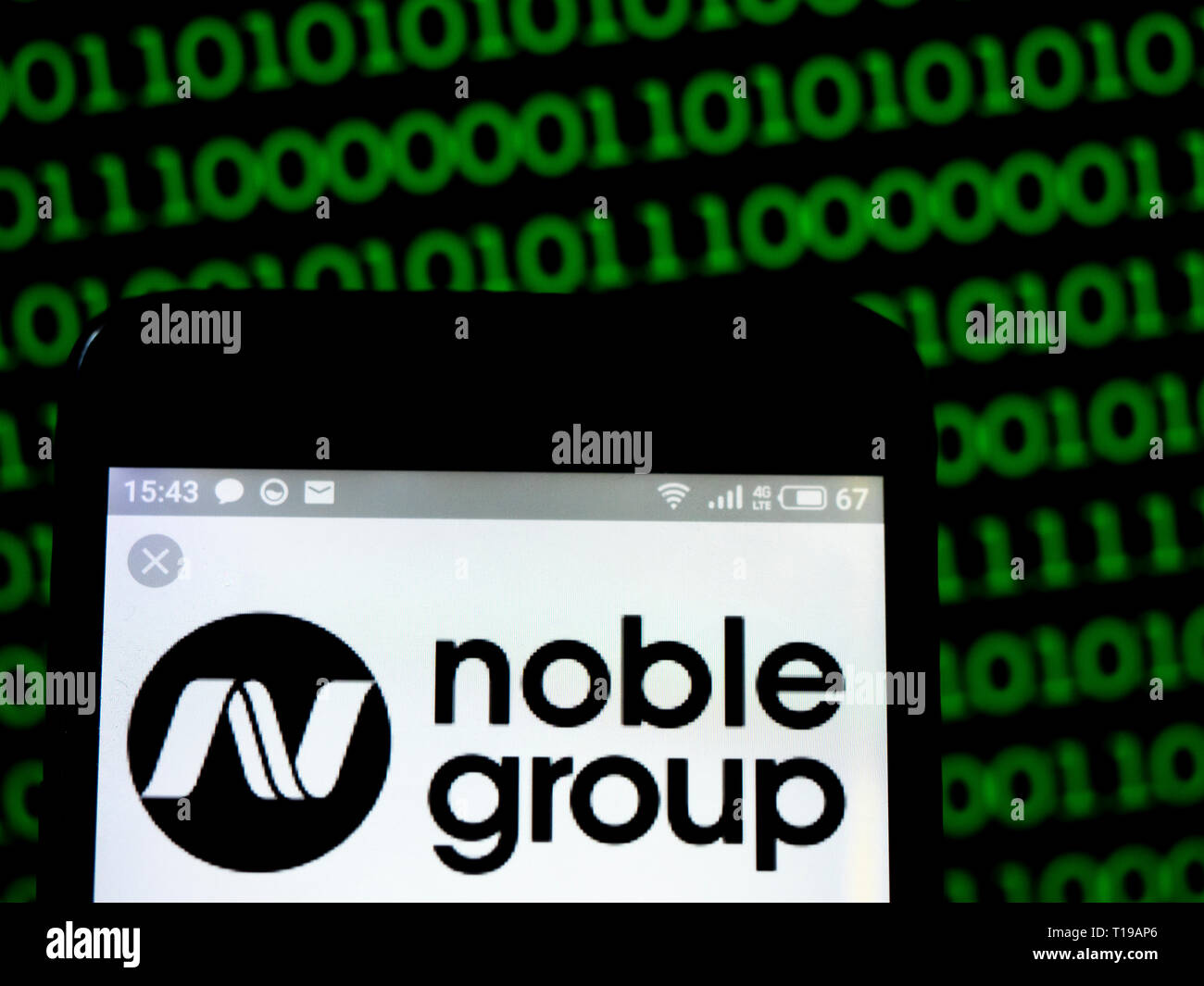 In this photo illustration a Noble Group logo seen displayed on a smart ...